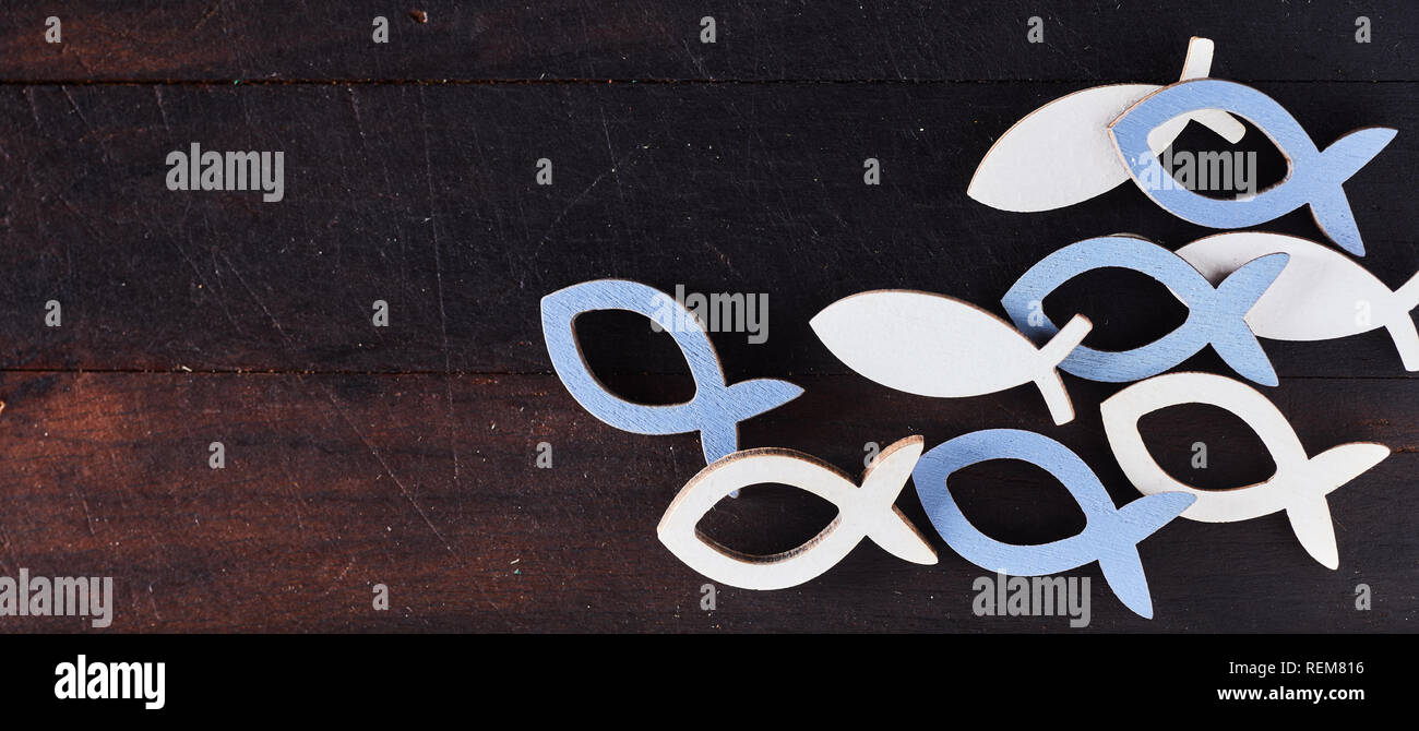 Catholic Holy Communion creative background with fish shapes on brown ...