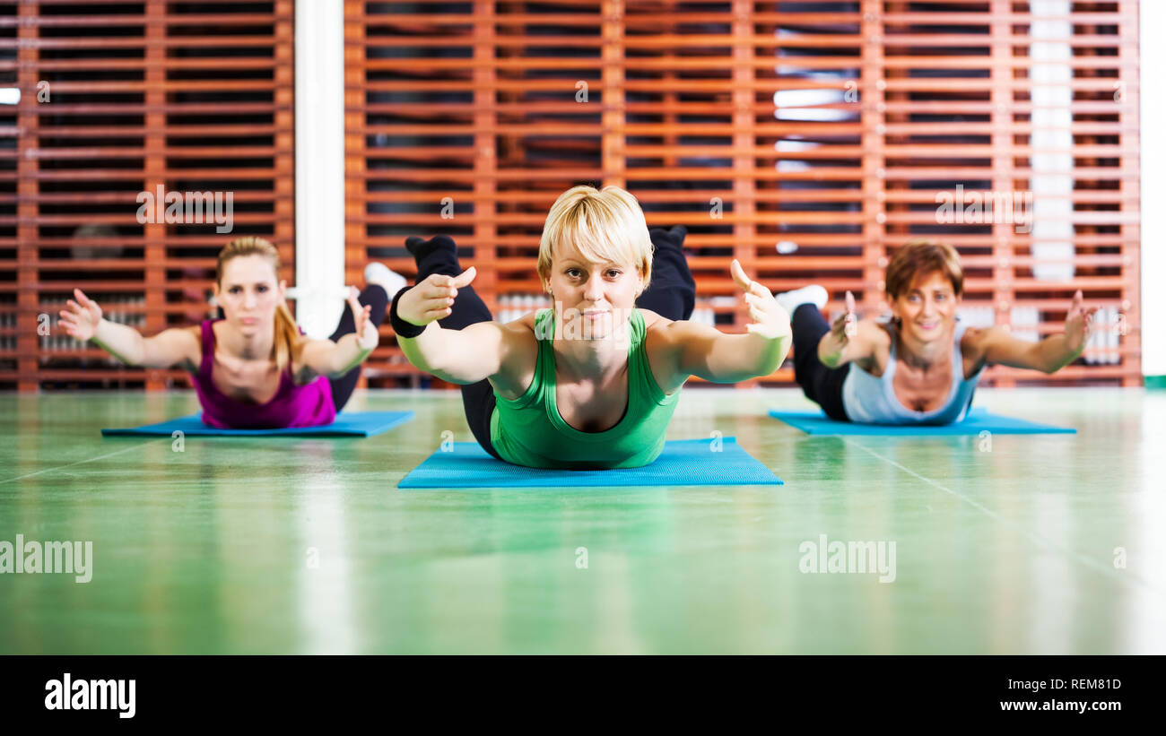 Girls practicing yoga, Yoga Salabhasana / variation of Locust pose ...