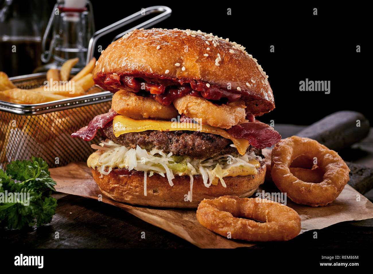 Surf and turf seafood and meat burger with fried squid rings, melted ...