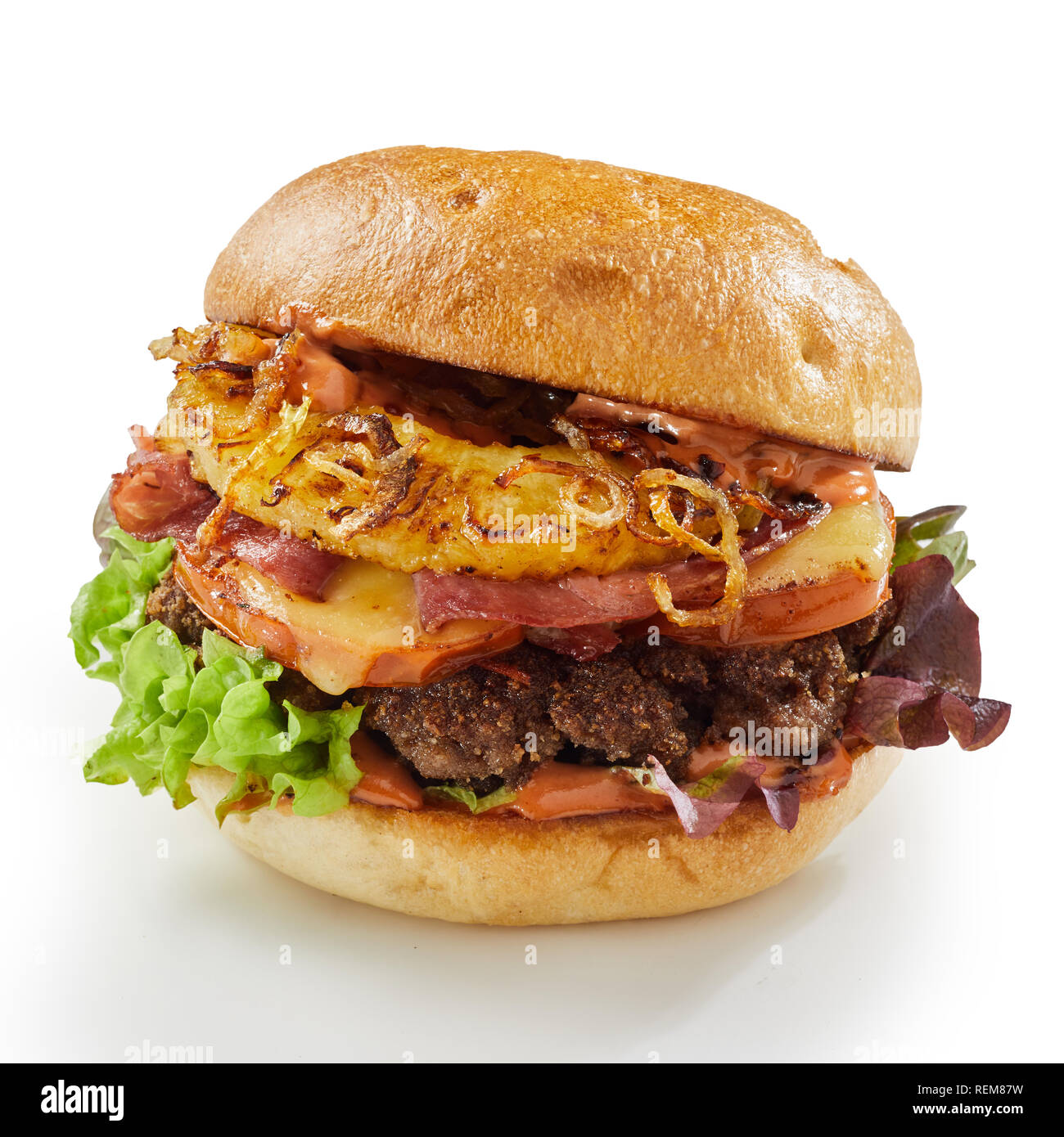 Pineapple and ham beef burger with fried onion and melted cheese on a ...