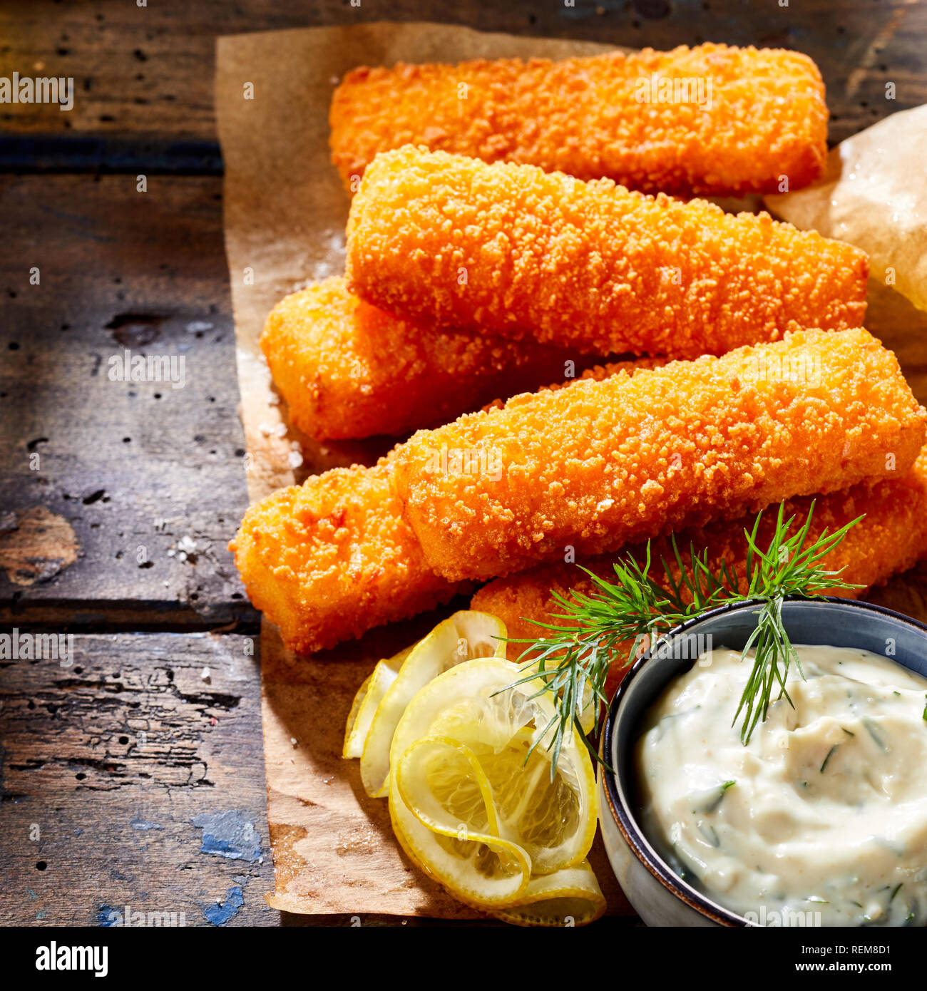 Tasty crispy deep fried fish fingers served with lemon and sauce Stock ...