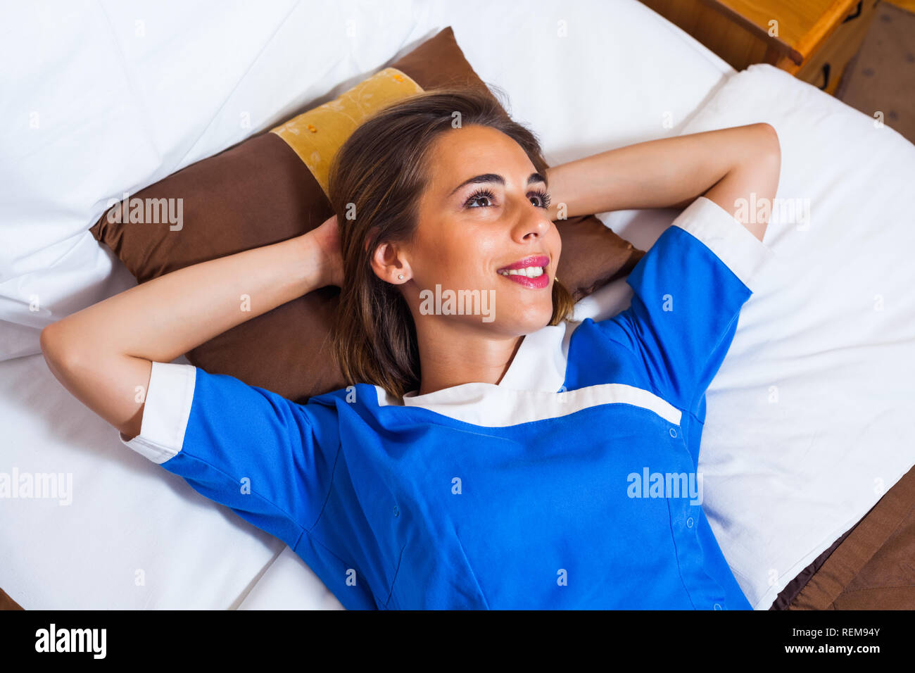 Portrait of hotel maid day dreaming Stock Photo - Alamy