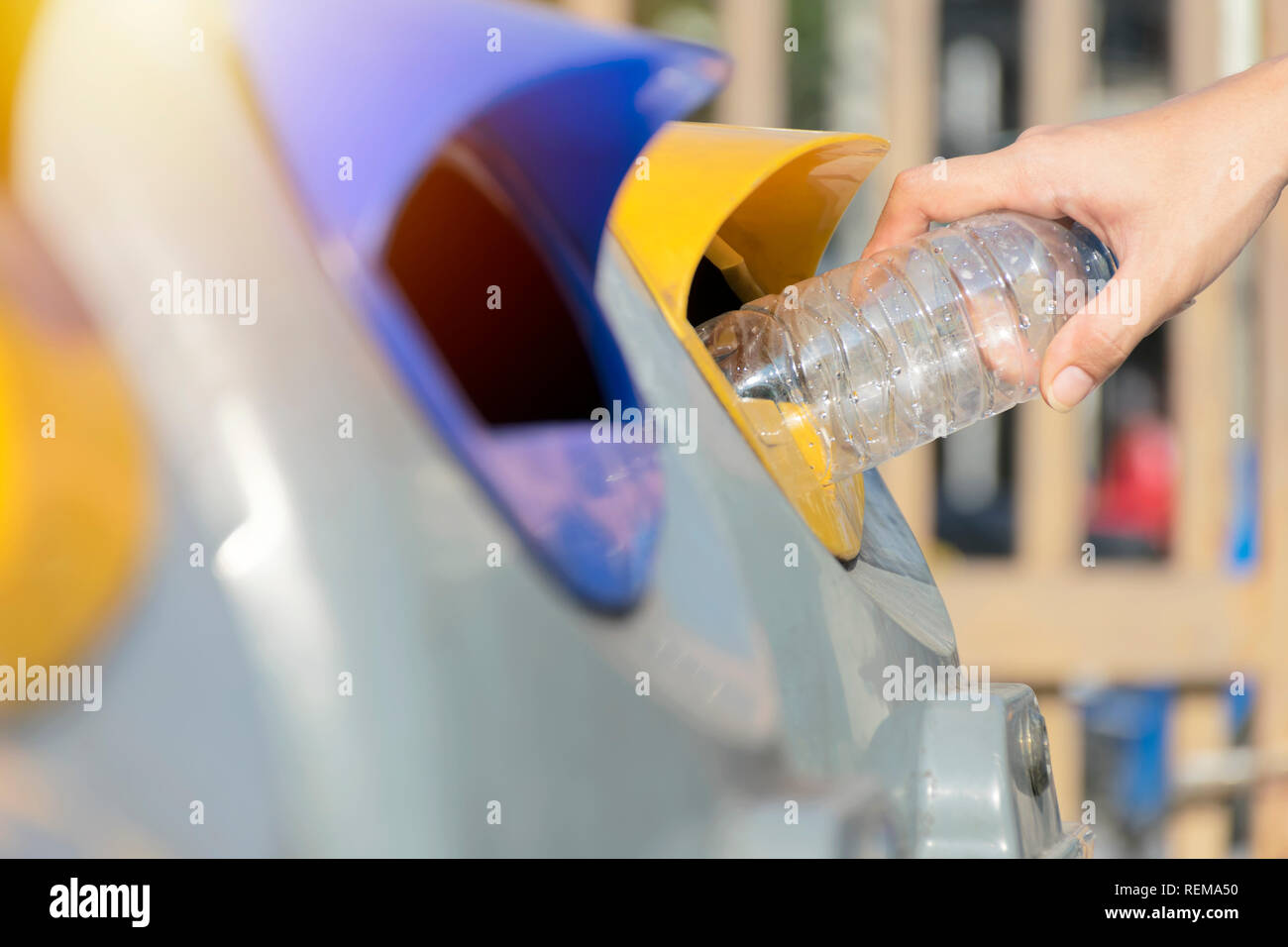 Close up hand throwing empty plastic bottle into the trash Recycling Concept. Dispose of ...