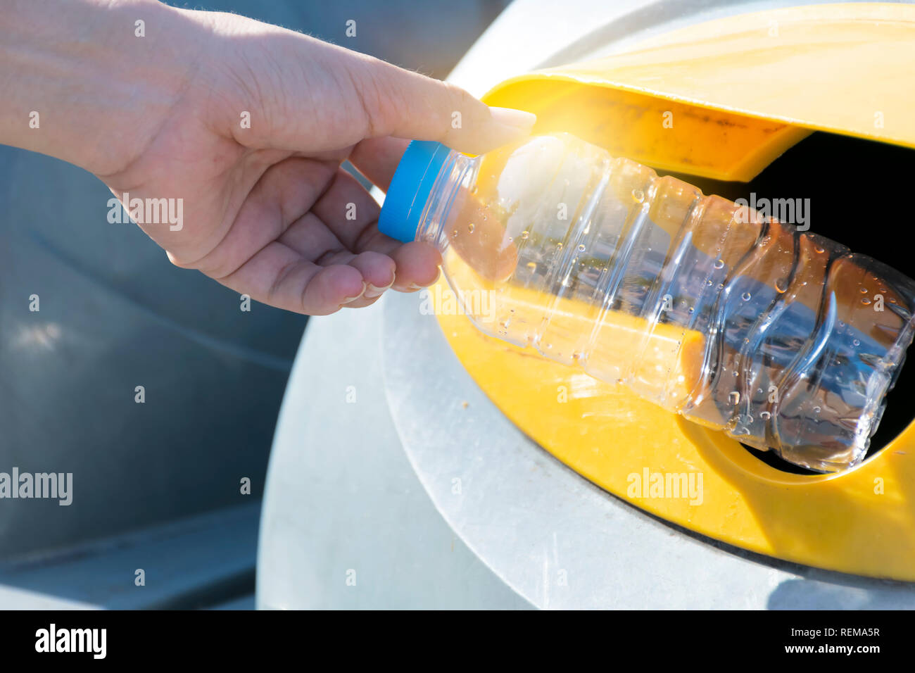 Close up hand throwing empty plastic bottle into the trash Recycling Concept. Dispose of ...