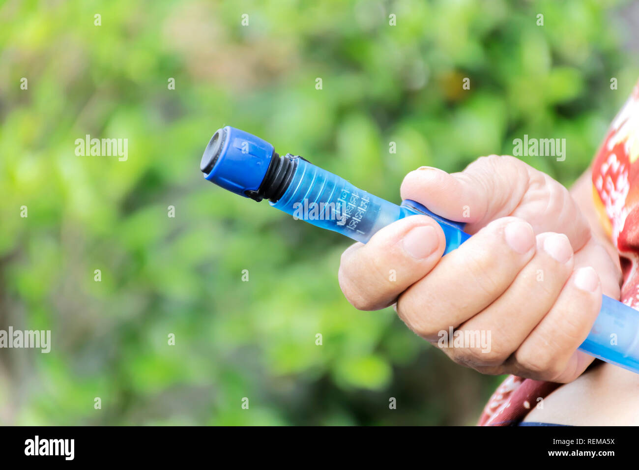 Close up of old female diabetes patient making subcutaneous insulin ...