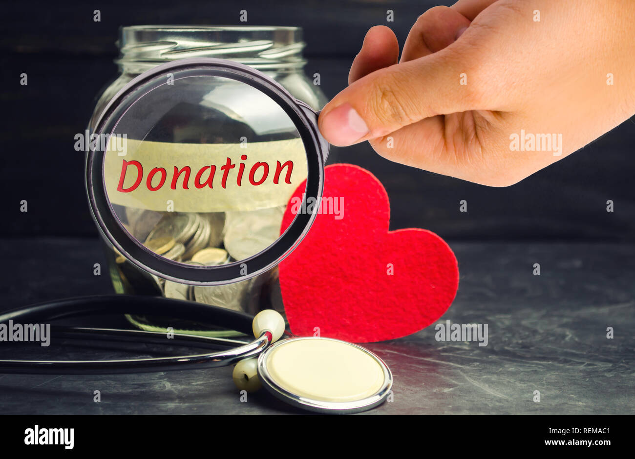 Glass jar with coins, heart and stethoscope and the inscription ...