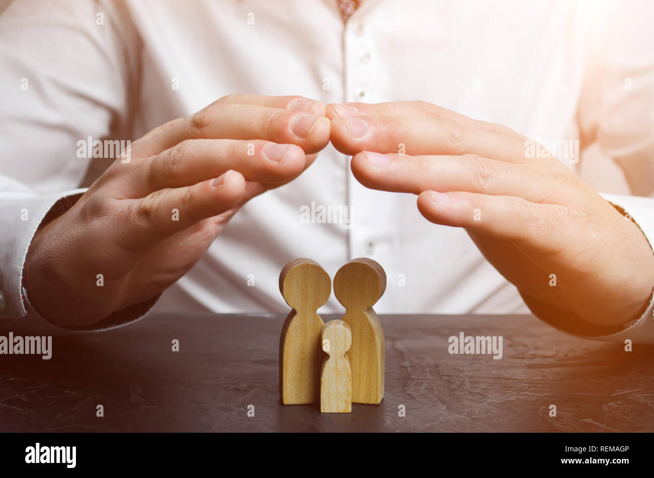 Insurance agent holds hands over family. The concept of insurance of ...