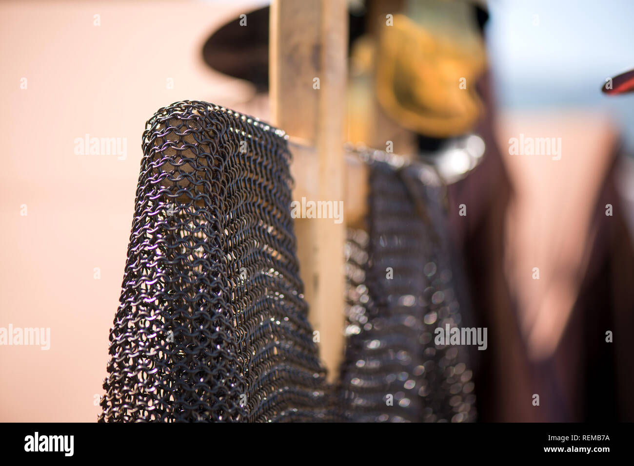 Medieval knight's iron chain armor on wooden cross hanger. Golden ...