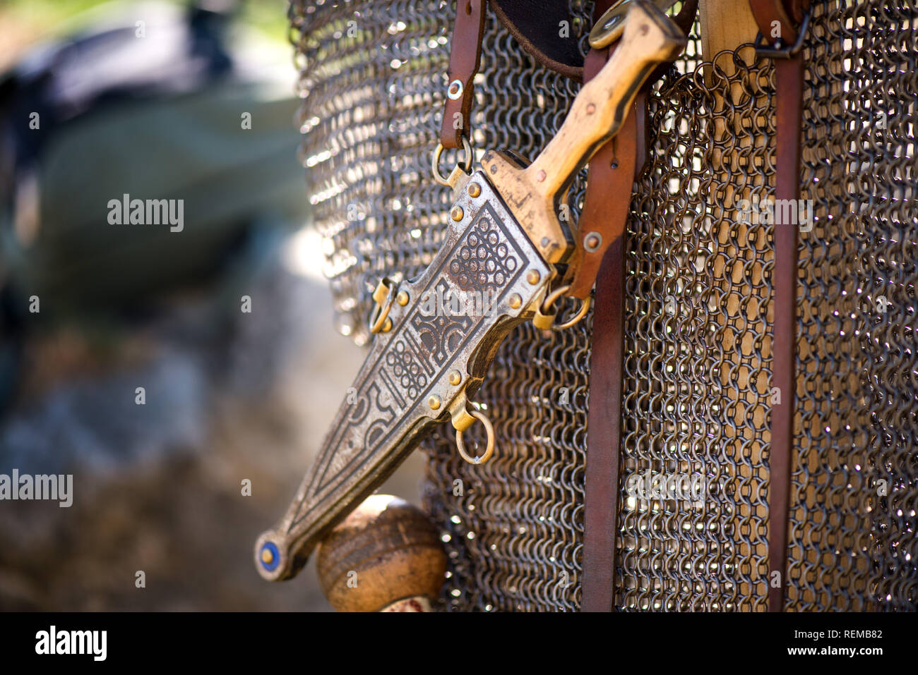 Silver or bronze medieval dagger with ornaments attached to chain ...
