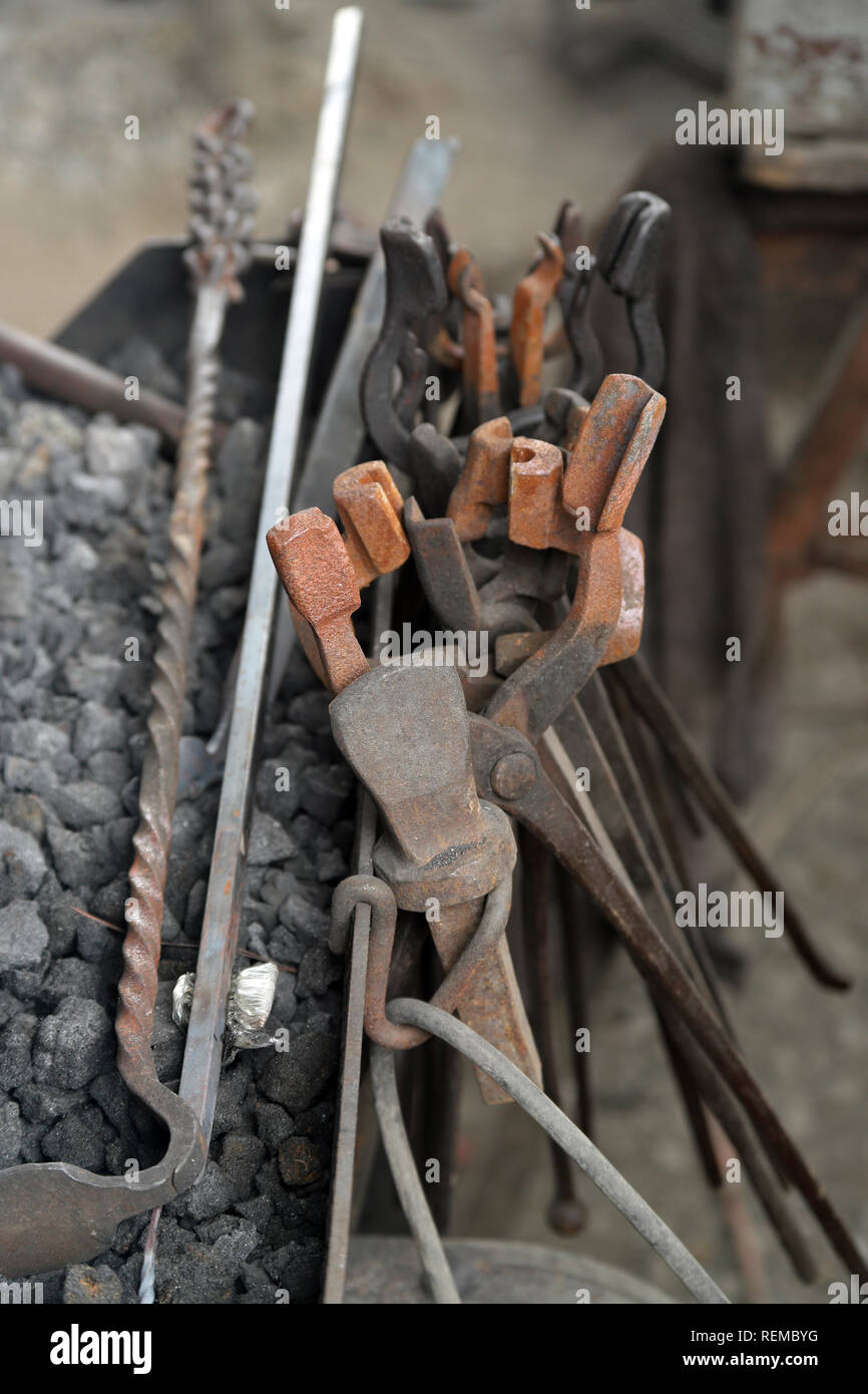 Blacksmith tools next to forge Stock Photo - Alamy