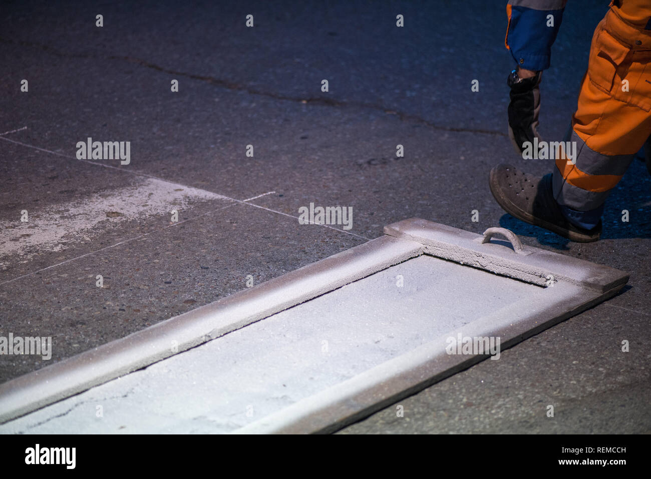 Traffic line painting. Workers are painting white street lines on ...