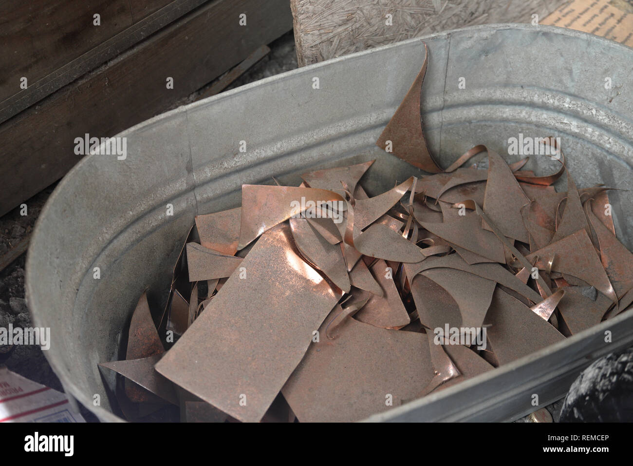 Copper scraps in tine bucket in blacksmith workshop Stock Photo - Alamy