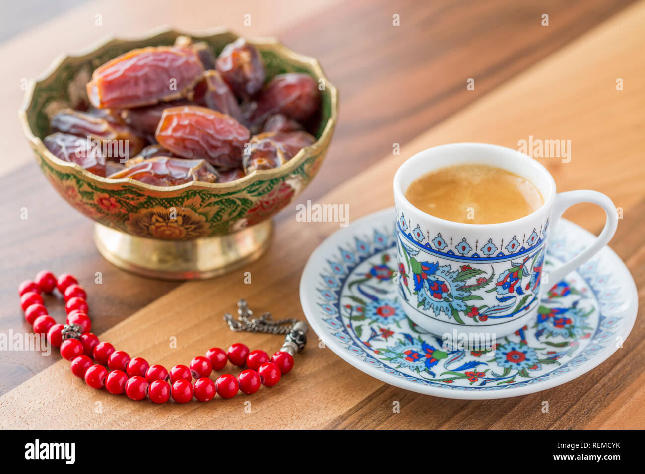 Turkish coffee, dates, and red rosary on table side view Stock Photo ...