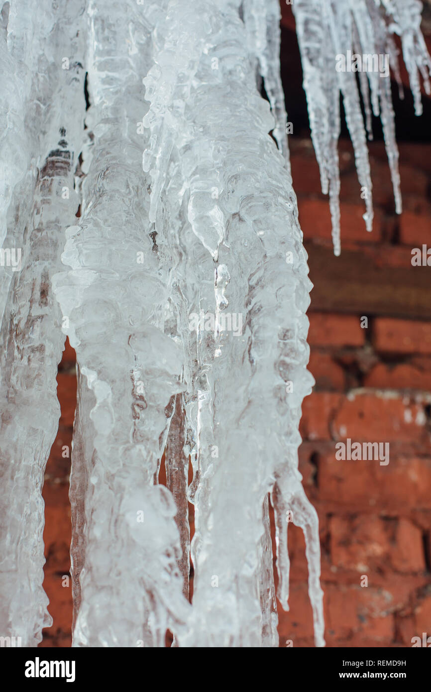 Very large and dangerous icicles in close up in winter Stock Photo - Alamy