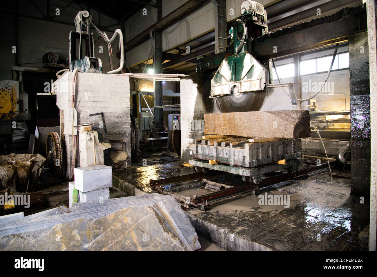 Granite processing in manufacturing. Cutting granite slab with a ...