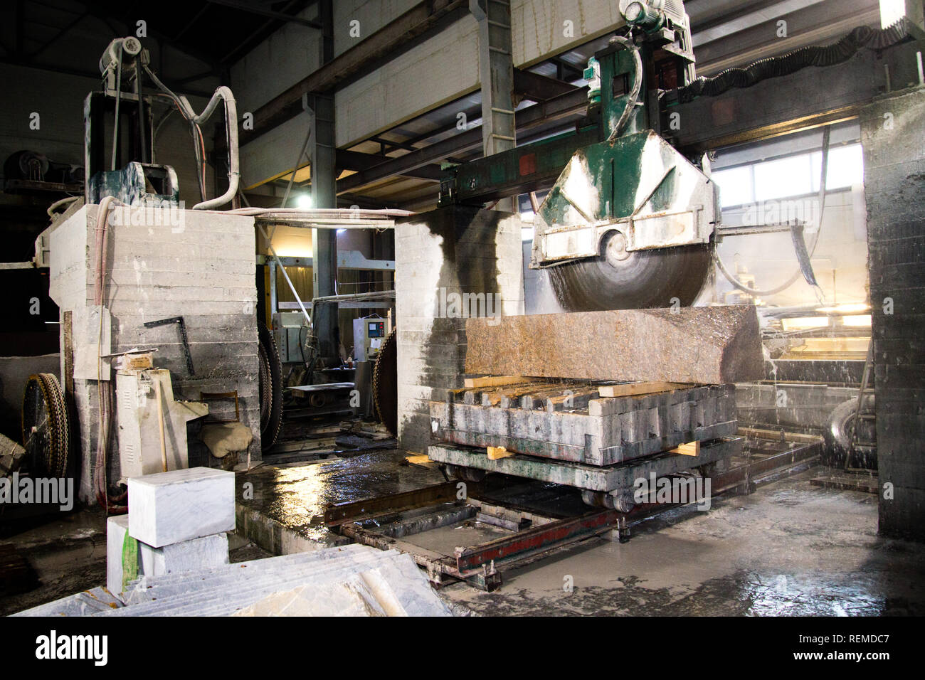 Granite processing in manufacturing. Cutting granite slab with a ...