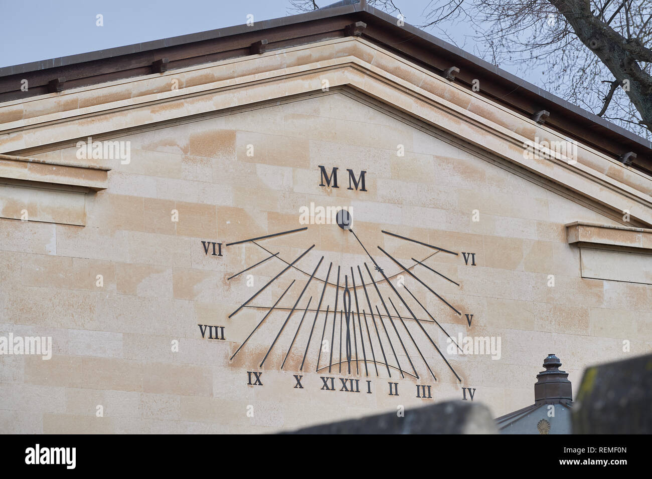 Modern sundial on the wall of a building at Magdalen college ...
