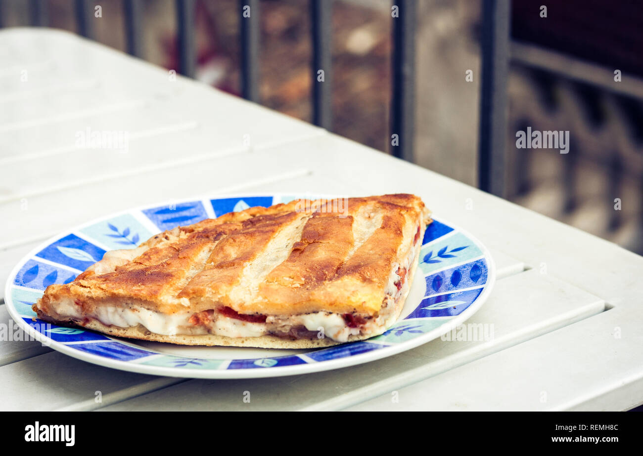 Fried calzone pizza with ham, mozzarella, tomatoes from bakery shop of ...