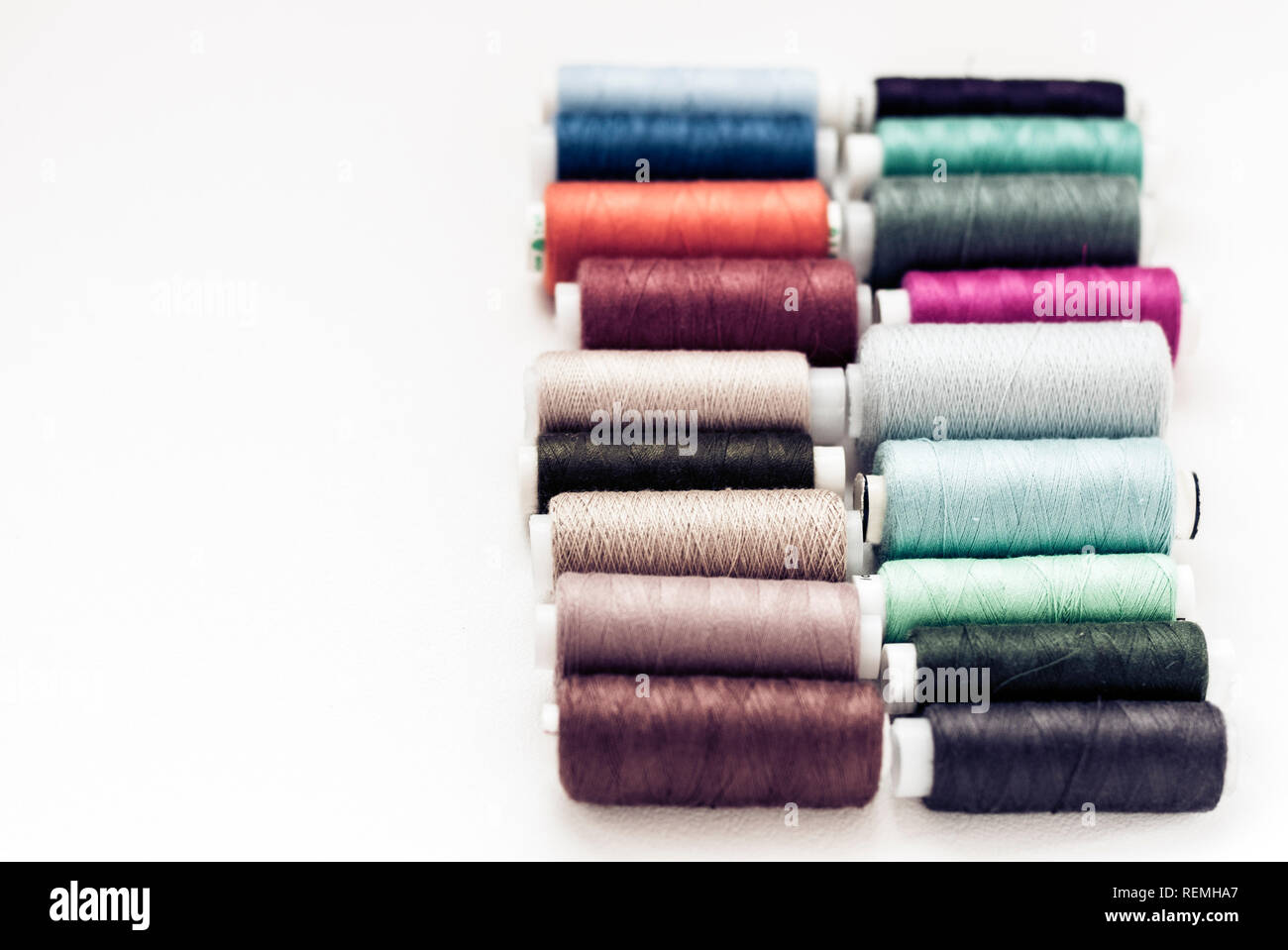 Colored sewing thread coils on white background with copy space for ...