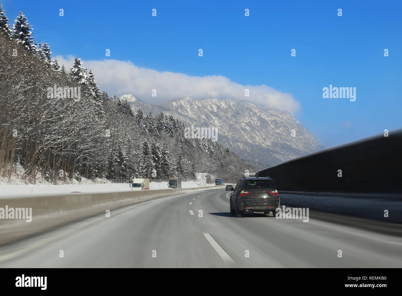 Car running on curve of empty winter highway road with beautiful ...