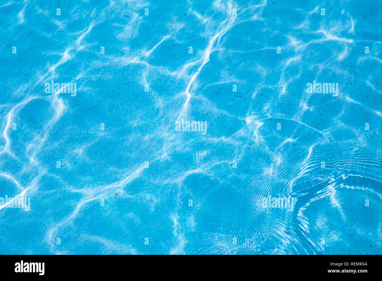Blue ripped water in swimming pool with sunny reflections for ...