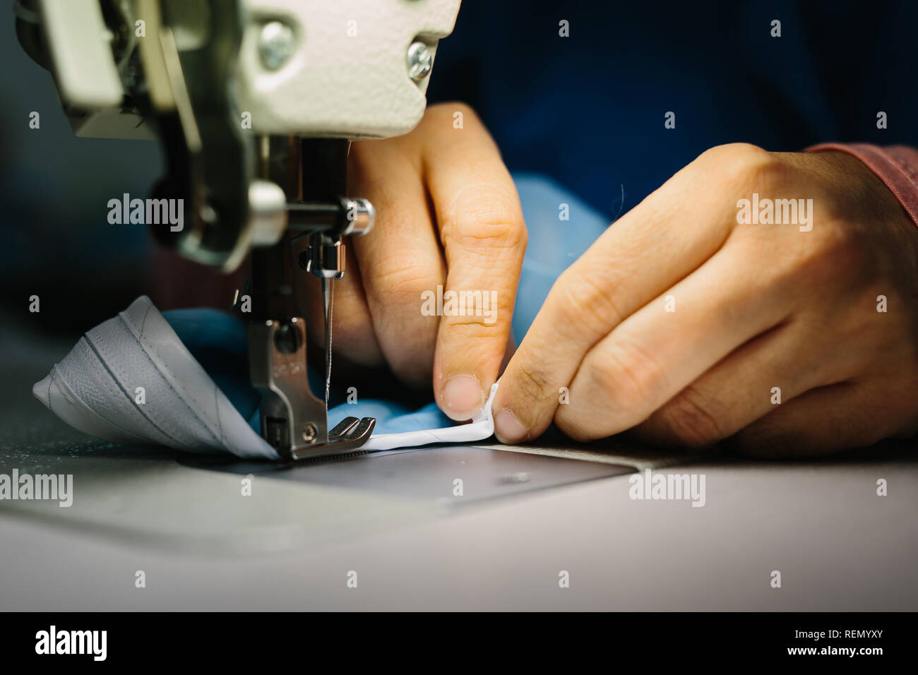 Barcelona, Spain -06 Apr 2018- Hands of a seamstress sewing medical ...