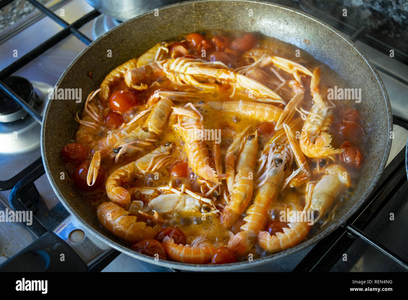 prawn sauce with pachino tomatoes in pan Stock Photo - Alamy