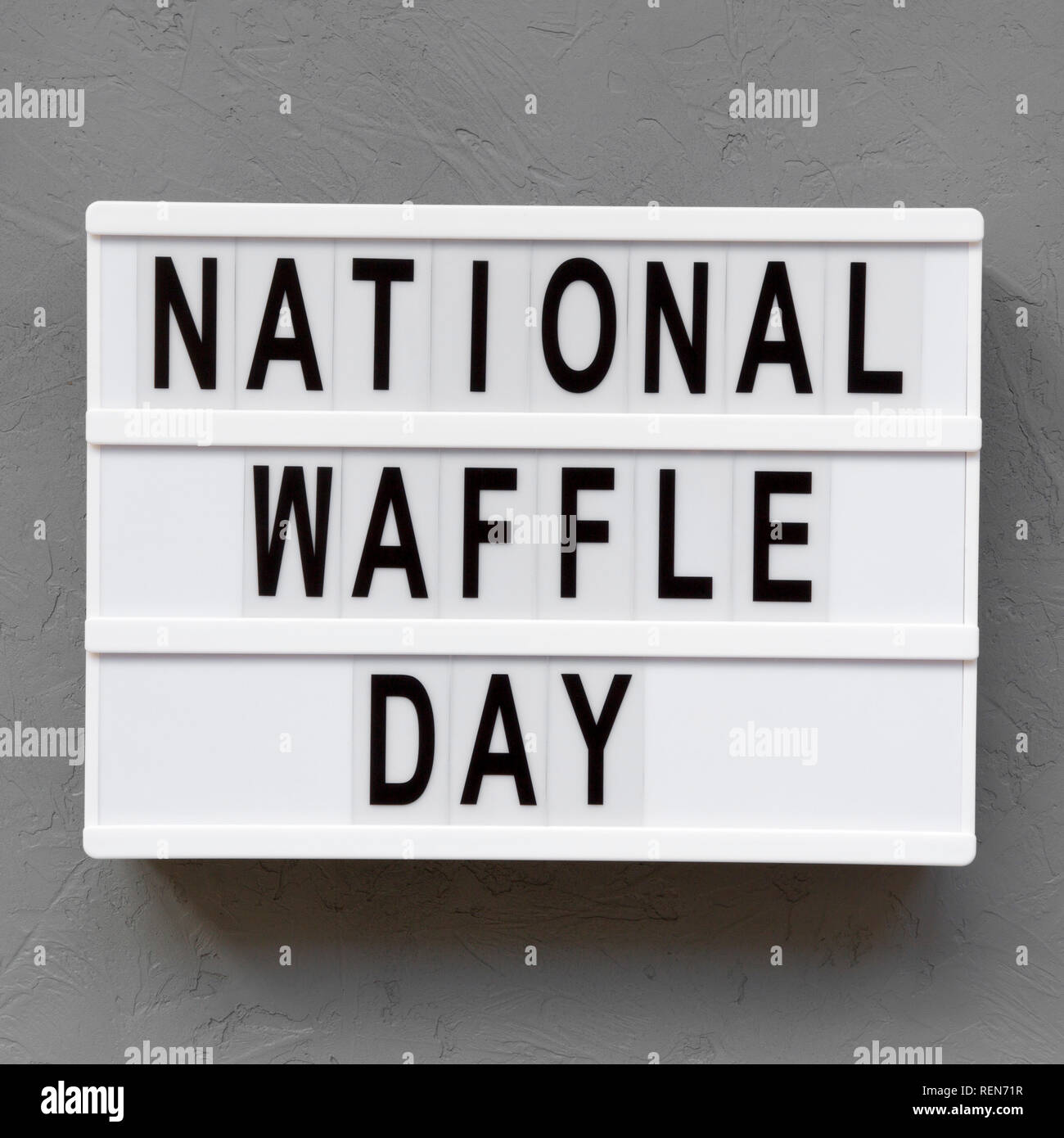 'National Waffle Day' word on modern board over concrete background ...