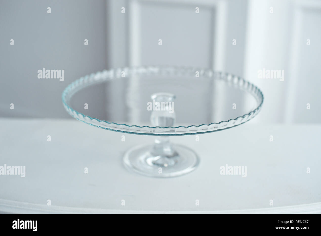 Glass cake stand on white table isolated on white background Stock ...
