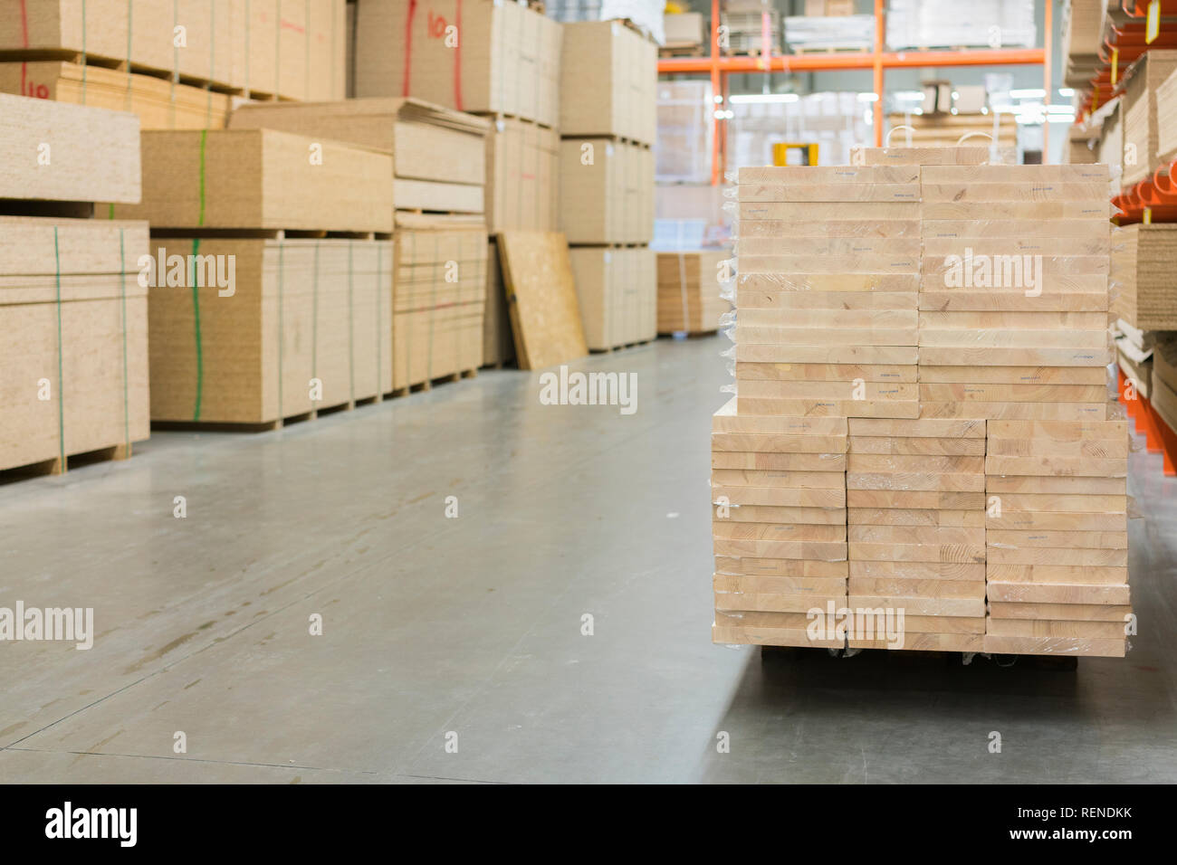 timber in warehouse. Pallet with boards in the hardware store. Packed ...