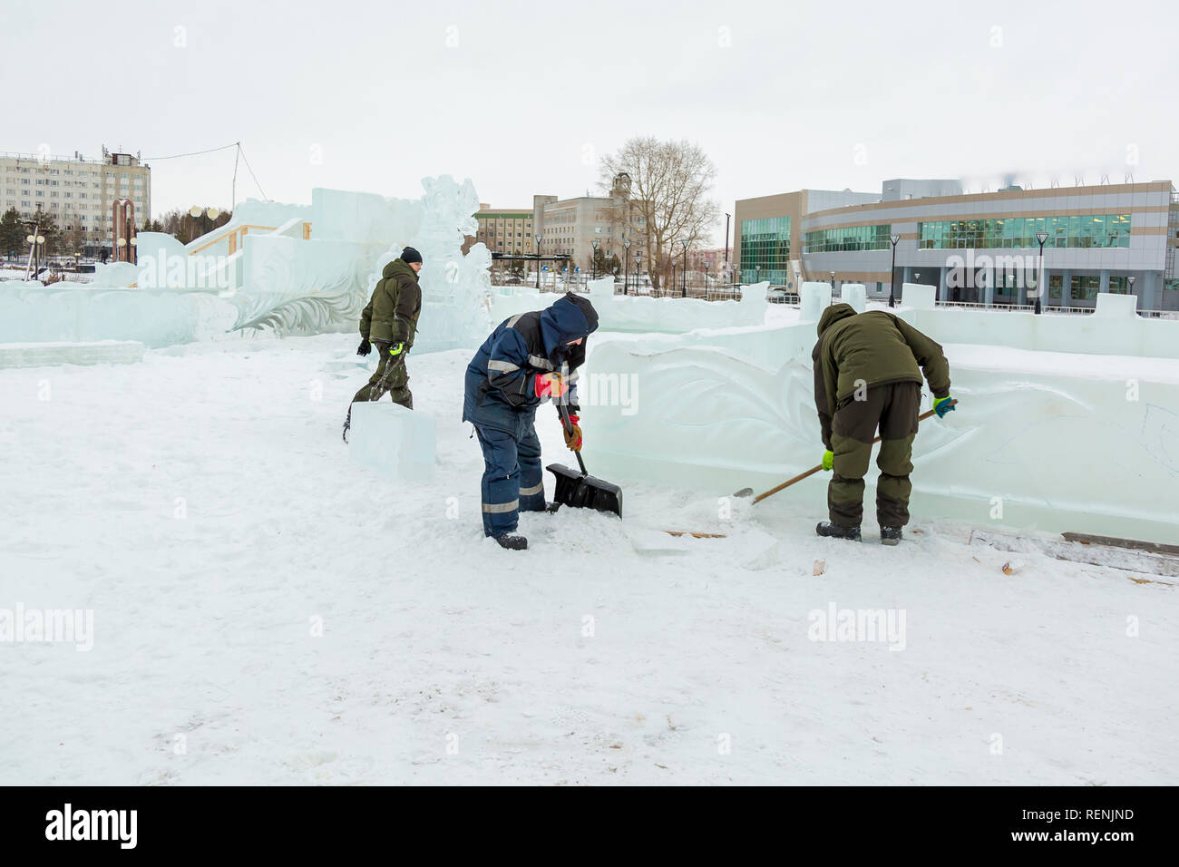 The worker pulls the ice block around the ice camp assembly site with ...