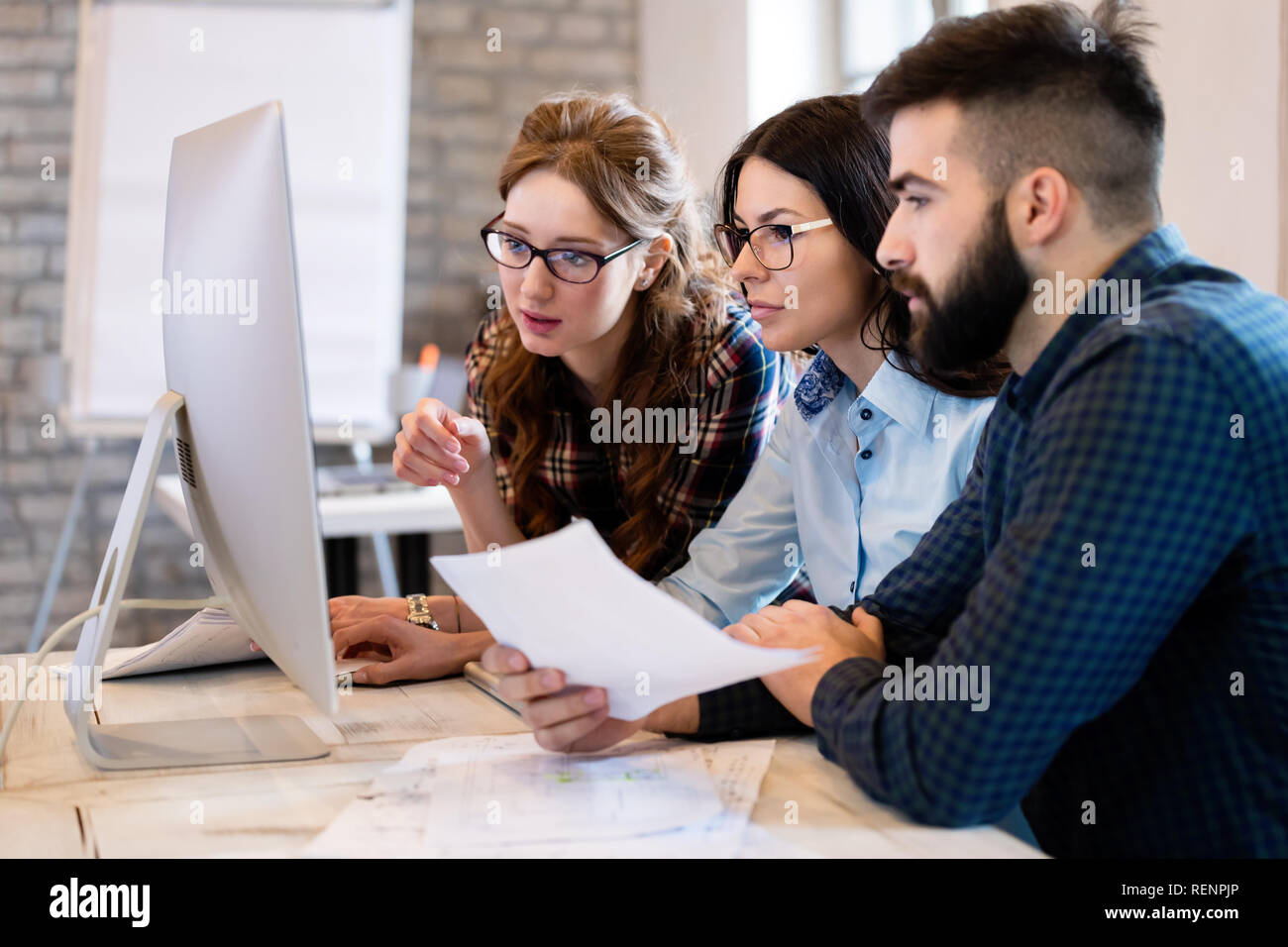 Young architects working on project in office Stock Photo - Alamy