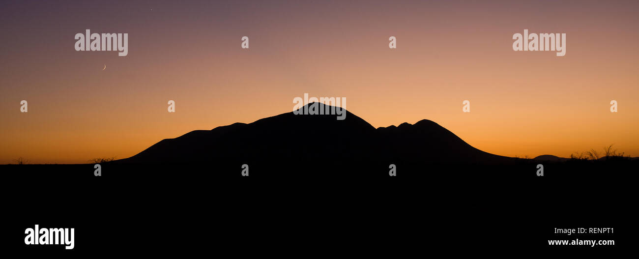 The Slender Profile of Mount Riley at Sunset with a Crescent Moon, in ...