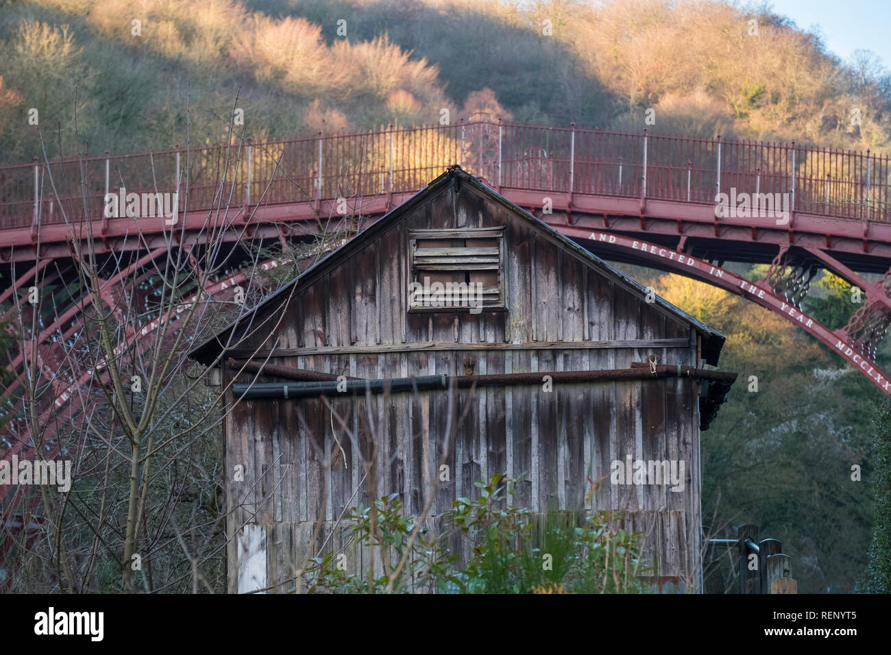 Winter sunlight on the red Iron Bridge at Ironbridge, Shropshire, with ...