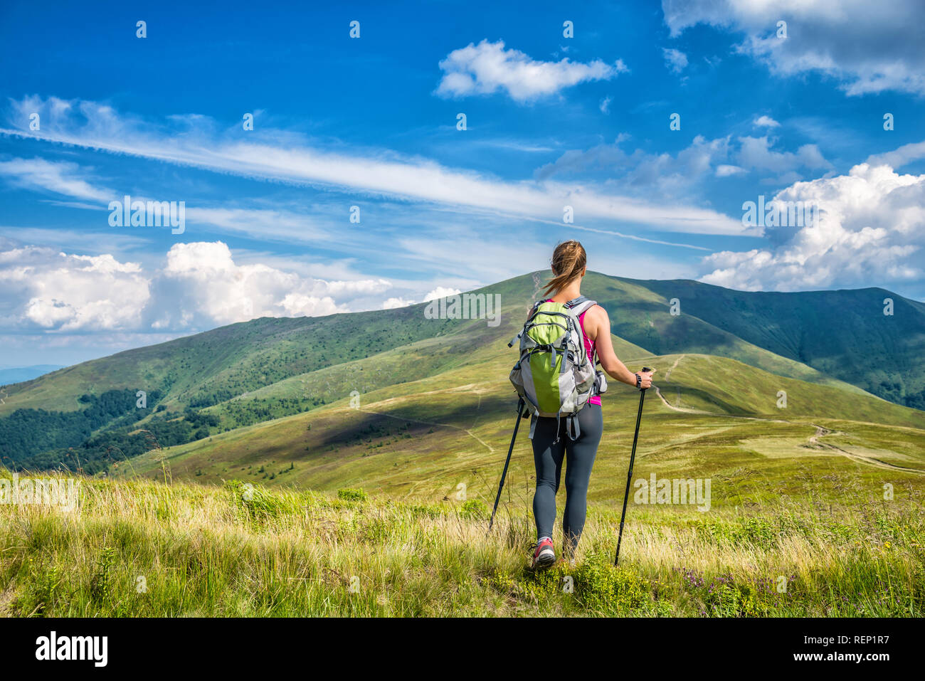 Young woman hiking in the mountains hi-res stock photography and images ...
