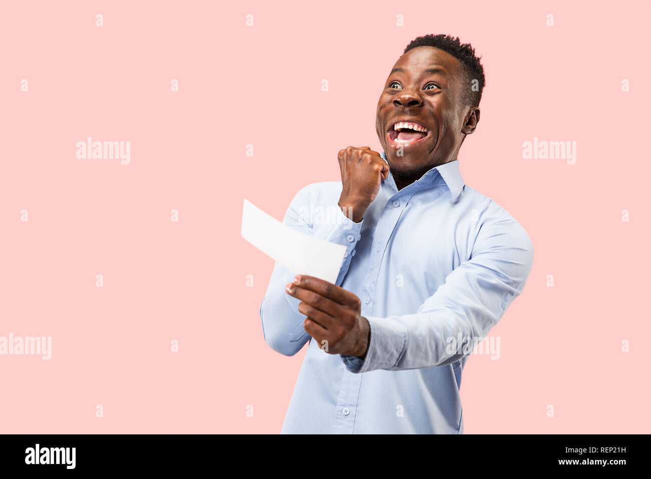 Young afro man with a surprised unhappy failure expression bet slip ...