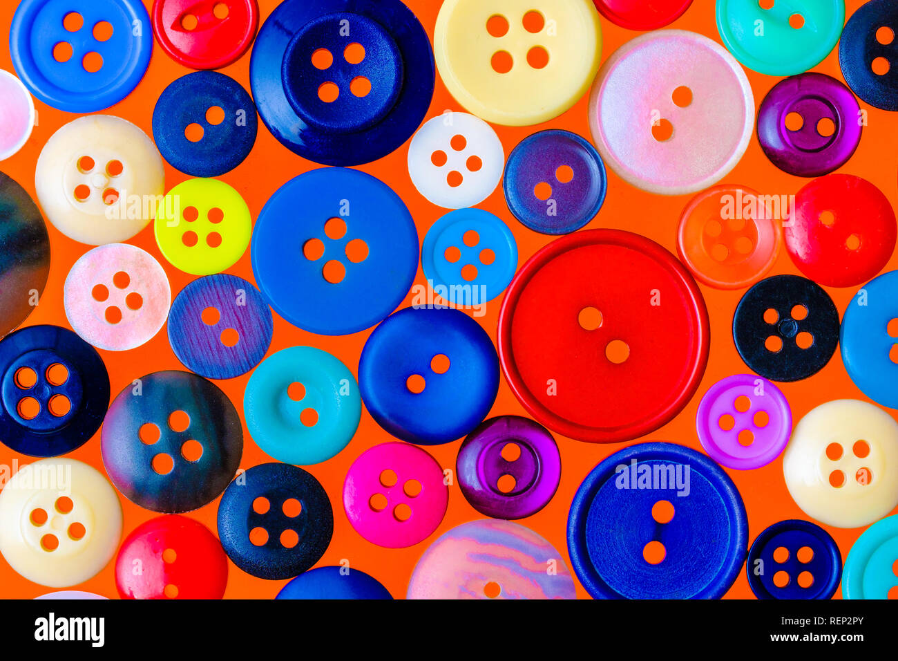 Collection of various sewing buttons on a red background Stock Photo ...