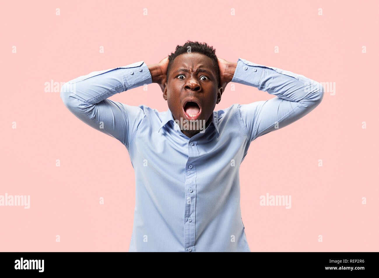 Screaming, hate, rage. Crying emotional angry man screaming on pink ...