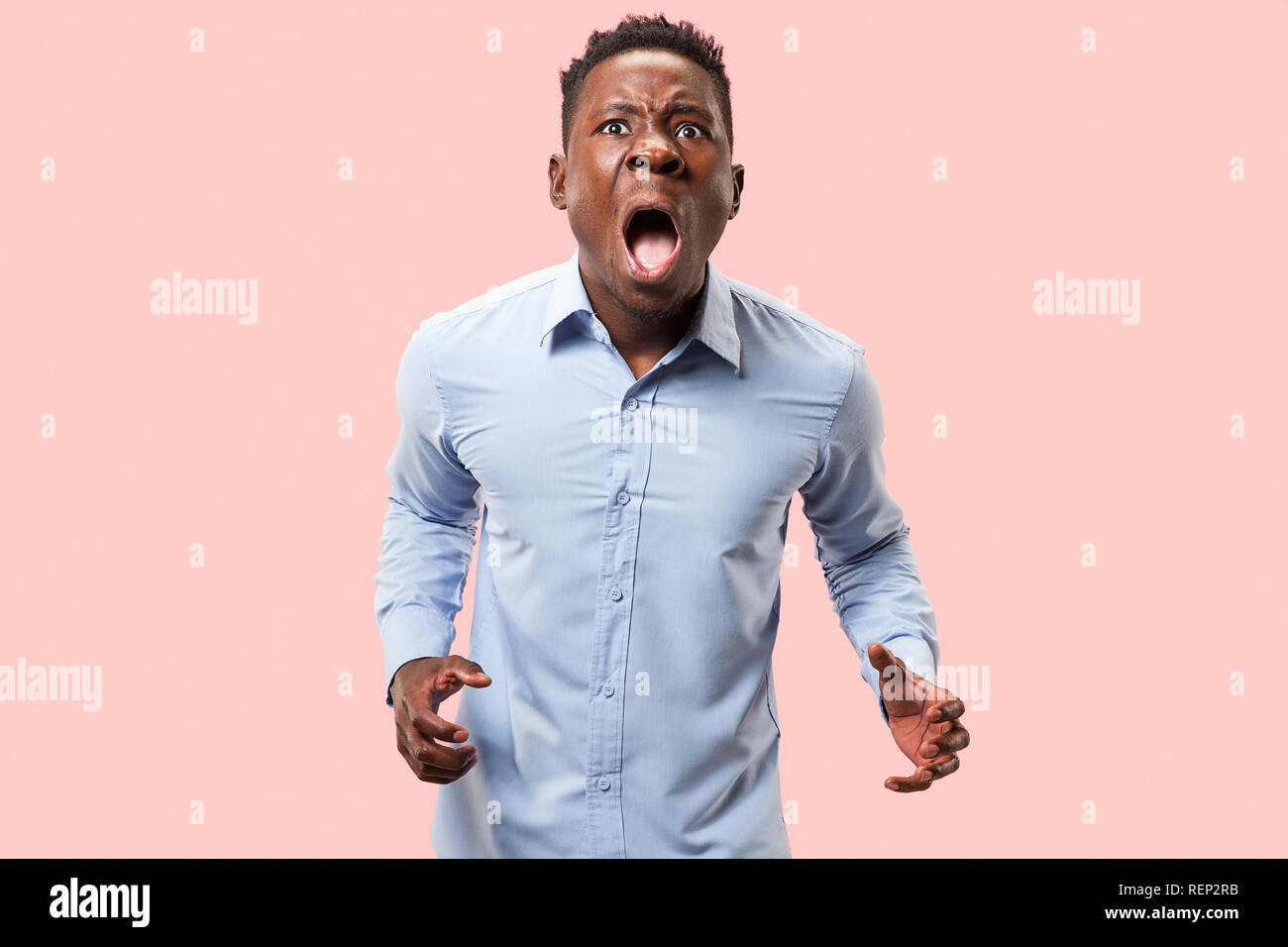 Screaming, hate, rage. Crying emotional angry man screaming on pink ...