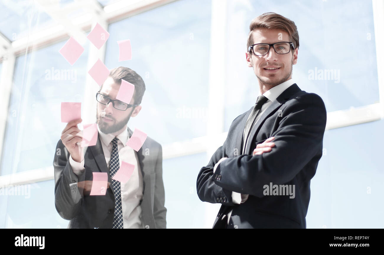 employee reading the stickers pasted on the glass wall Stock Photo - Alamy