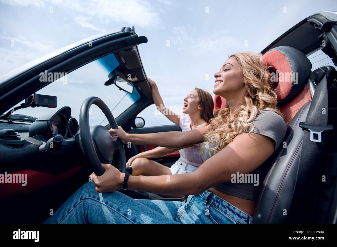 side view.two happy girls riding in the car Stock Photo - Alamy