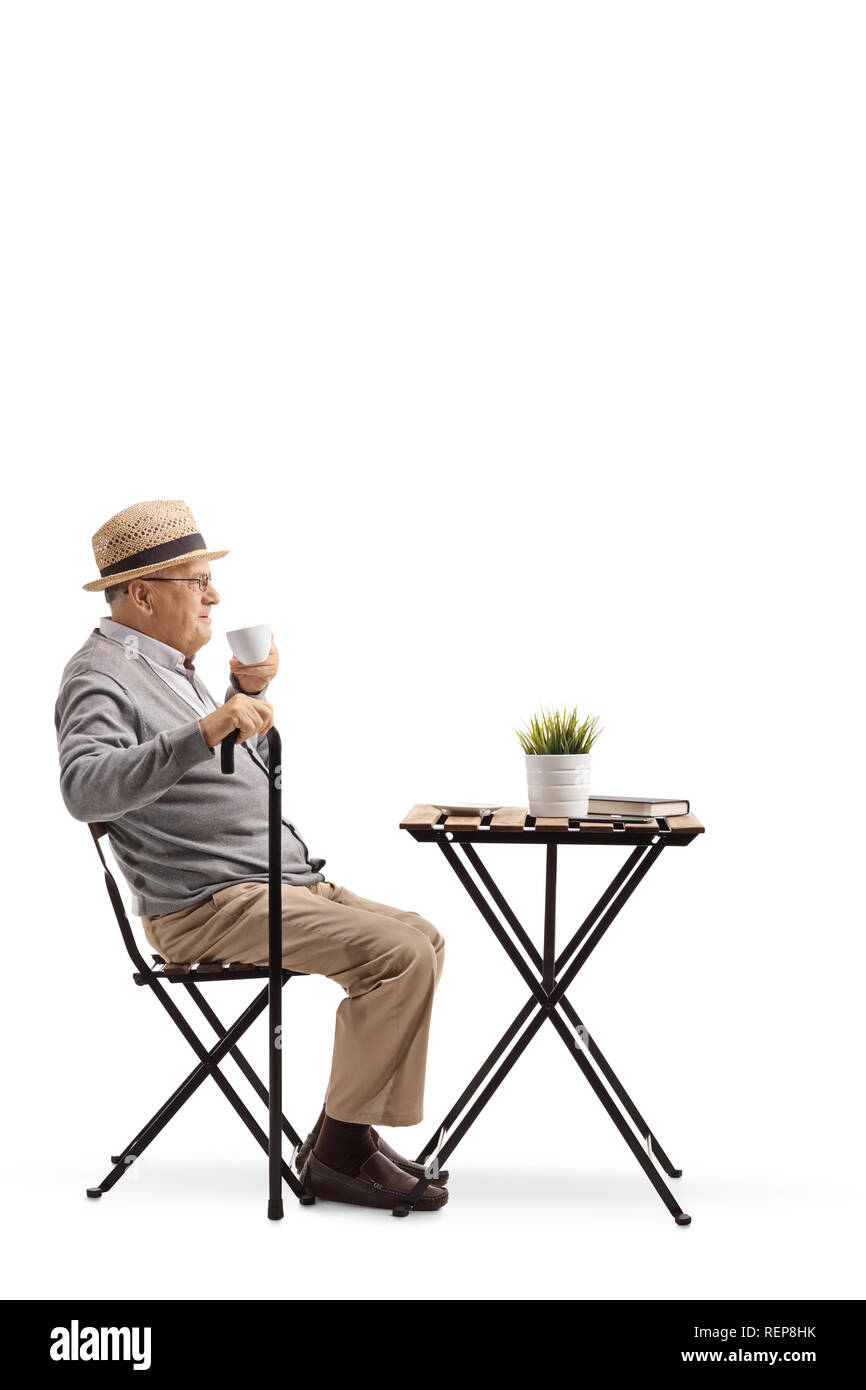Full length profile shot of a senior man with cane sitting and drinking ...