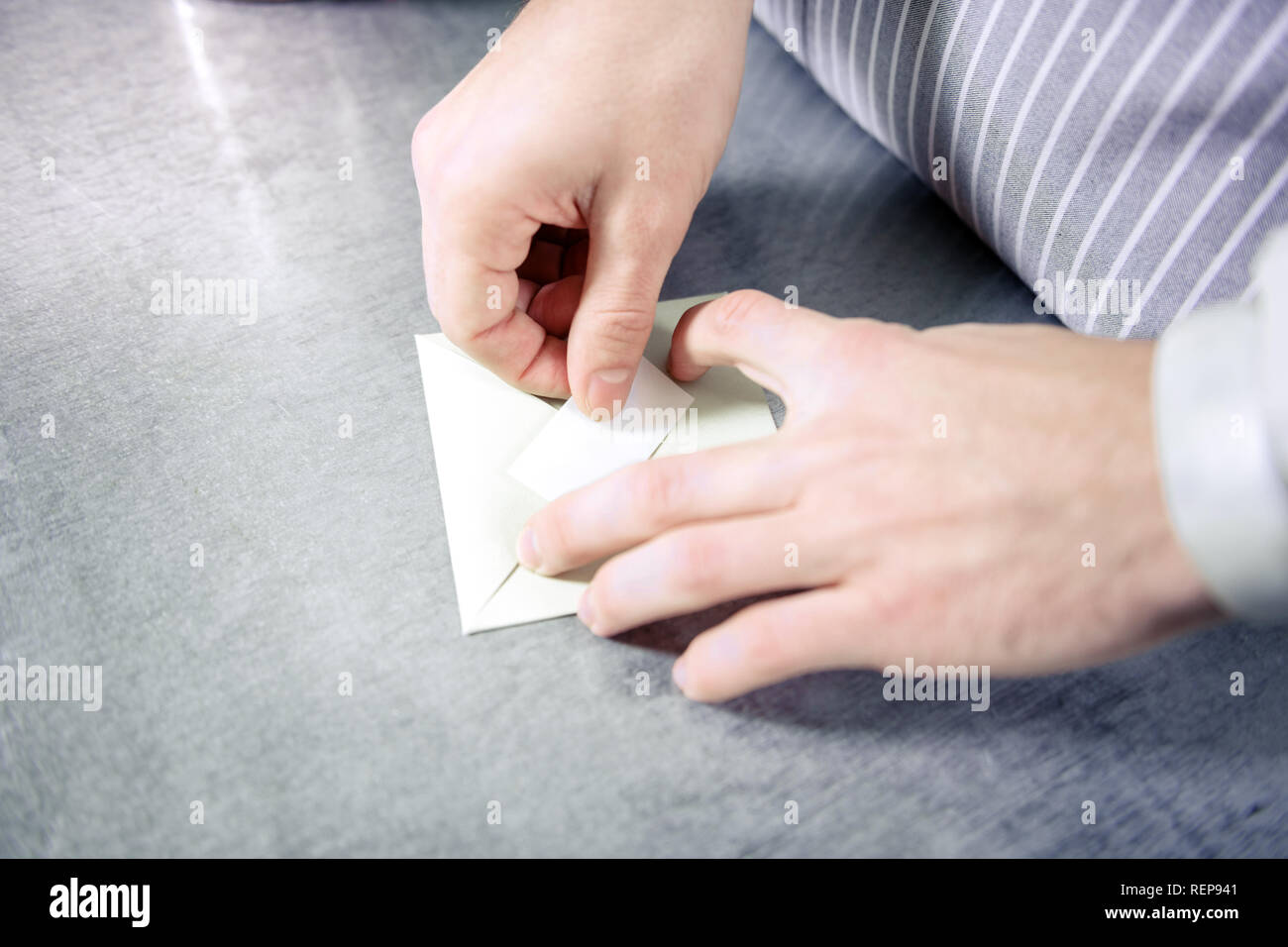 Close up of male hands that hiding paper into envelope Stock Photo - Alamy