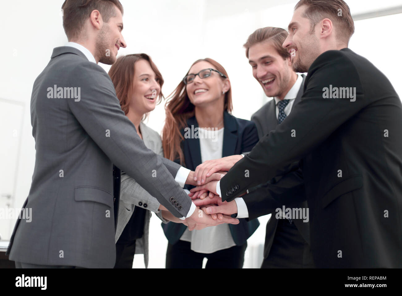 Close-up of people holding hands together while Stock Photo - Alamy