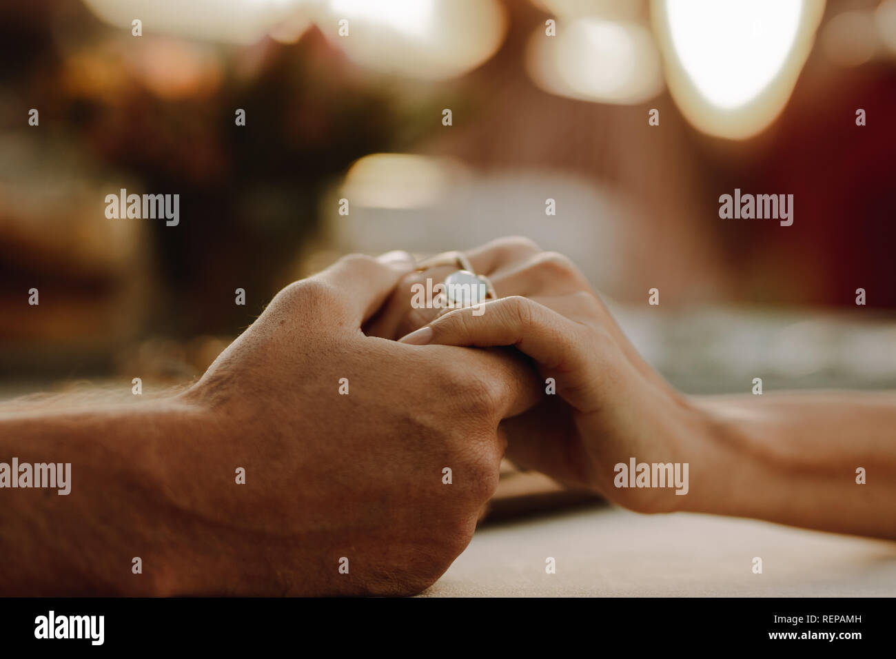 Couple holding hands dinner table hi-res stock photography and images ...