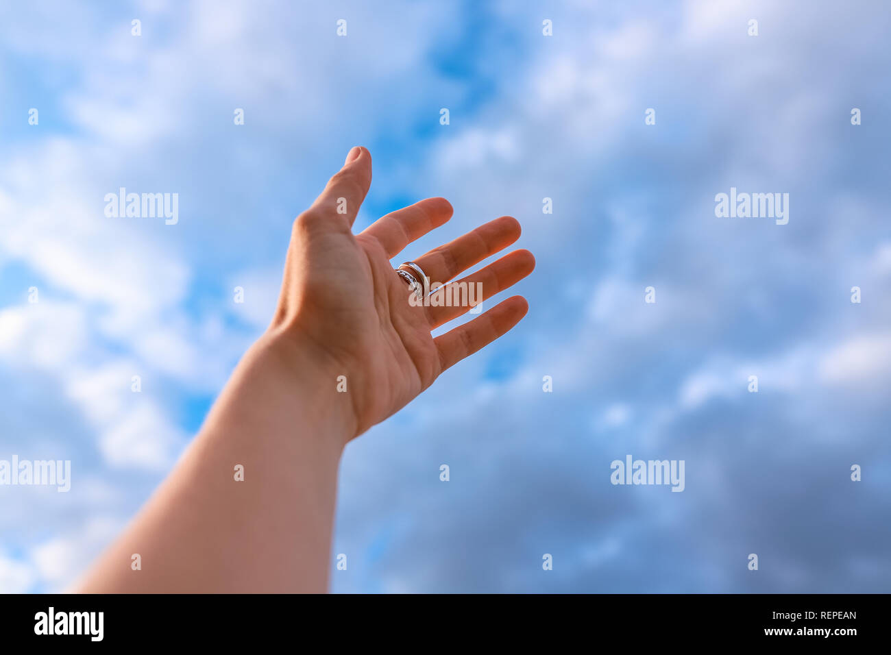 Hand Reaching Up To Sky