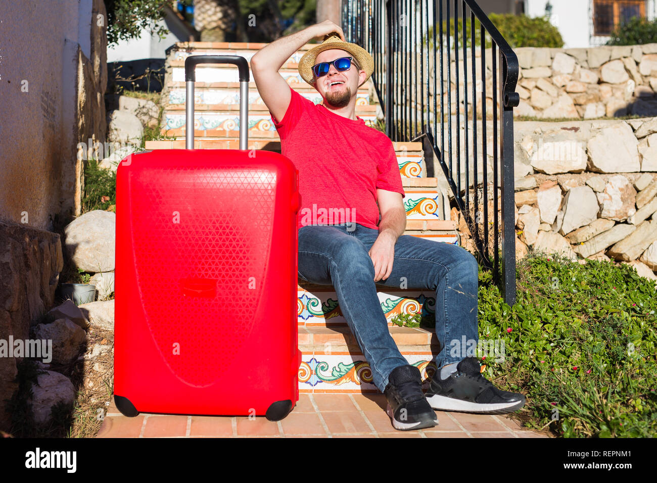 People, holidays, travelling and rest concept - young man sitting on ...