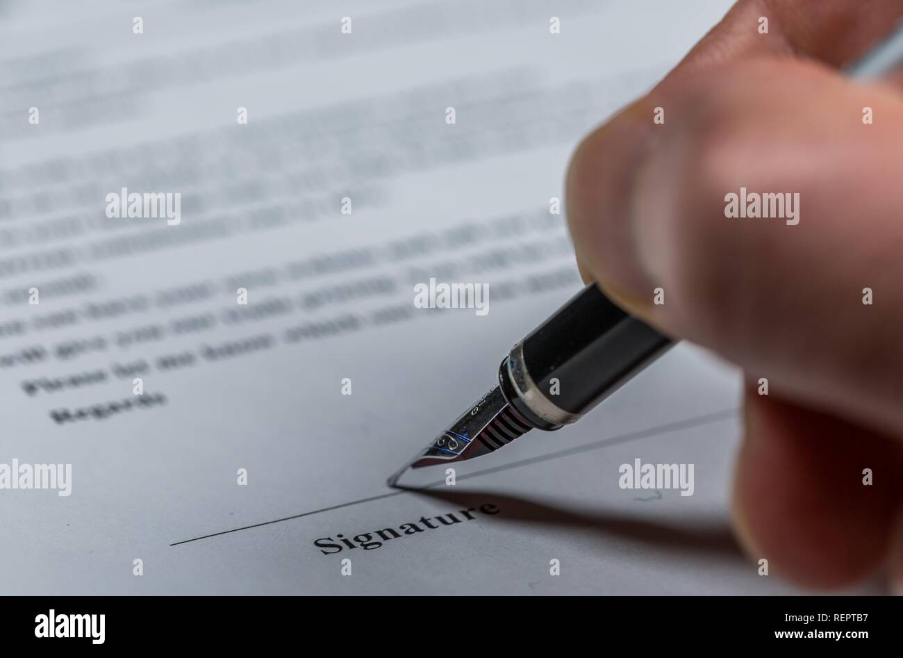 Close-up of a man hand signing on financial document Stock Photo - Alamy