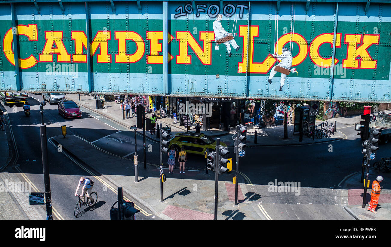 Mural depicting two painters painting Camden Lock on railway bridge ...