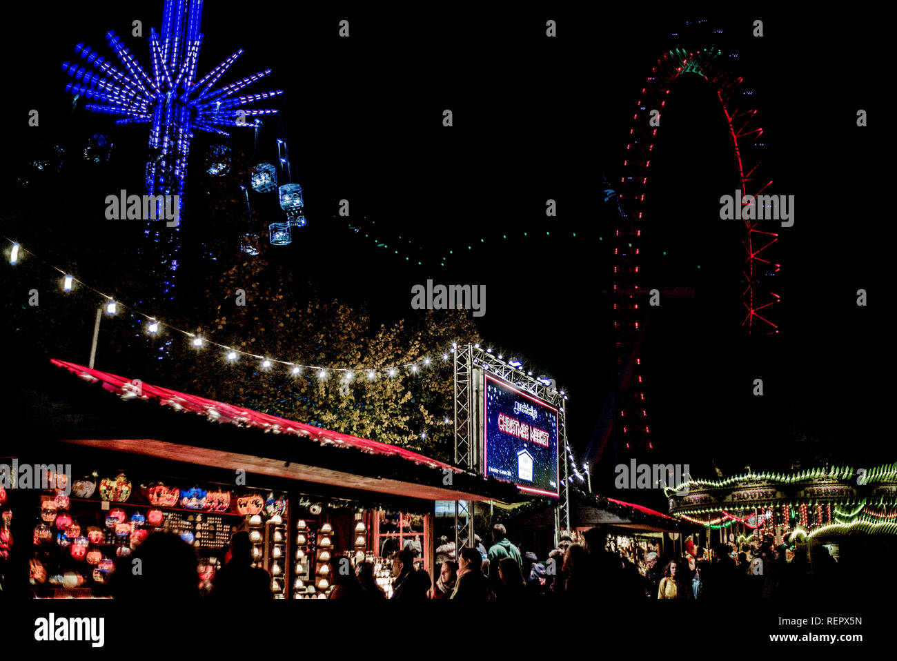 night time at christmas fun fair on south bank London, carousel and ...